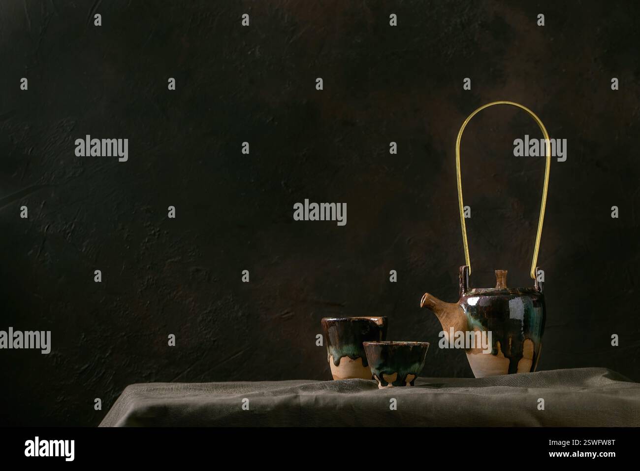 Craft handmade ceramic teapots with dark background Stock Photo - Alamy