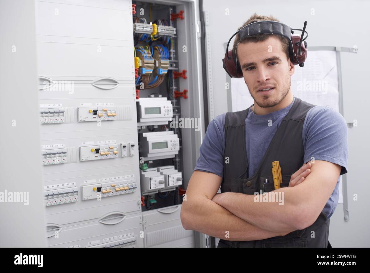 Portrait, electrical engineer and man with arms crossed, control room ...