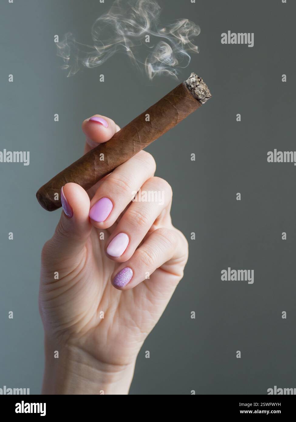 Cuban cigar in hand. A woman hand holding a burning cigar Stock Photo ...