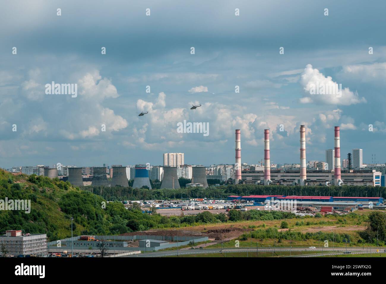 Helicopters over the city. Helicopters fly over an industrial area on ...