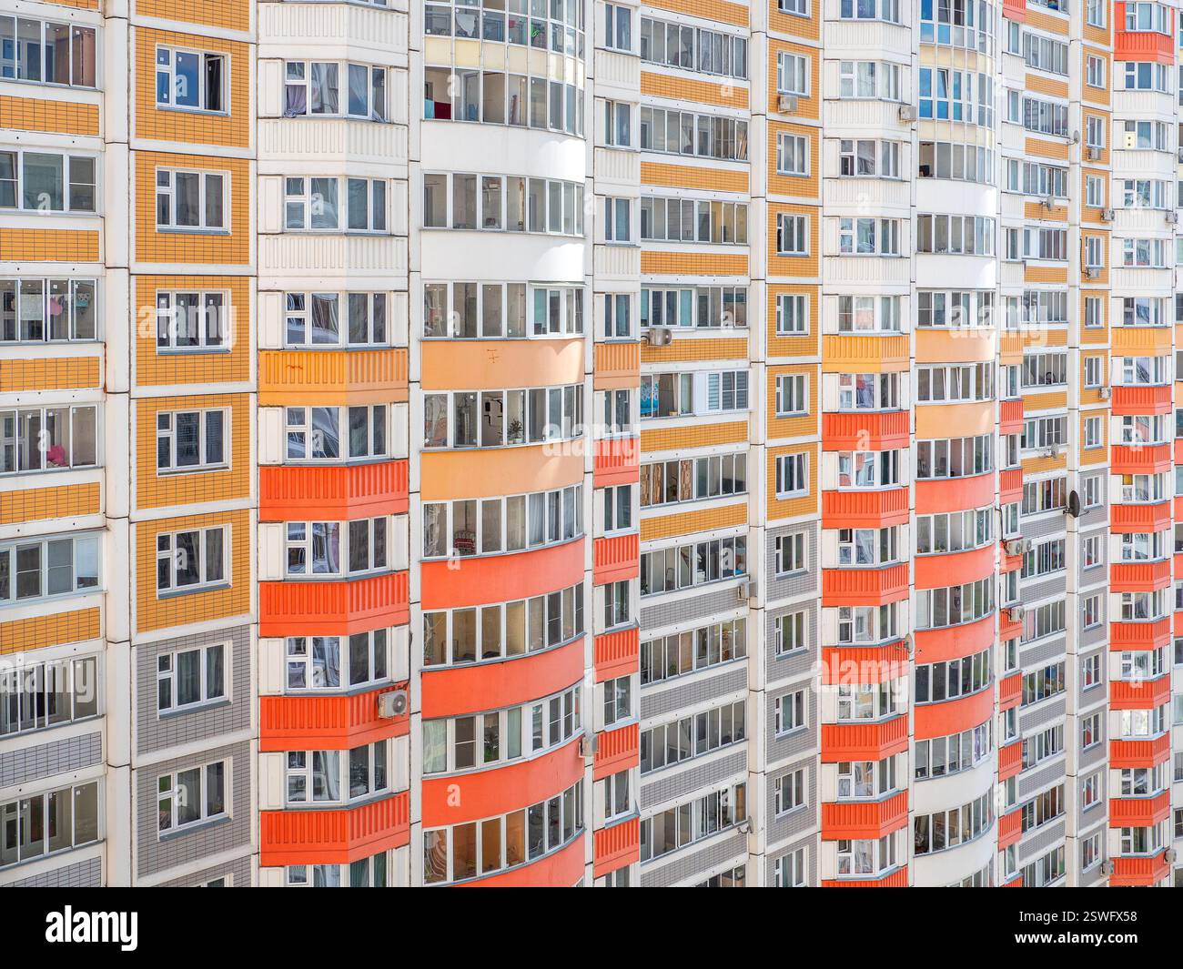 Fragment of a wall with windows of a multi-storey apartment building ...
