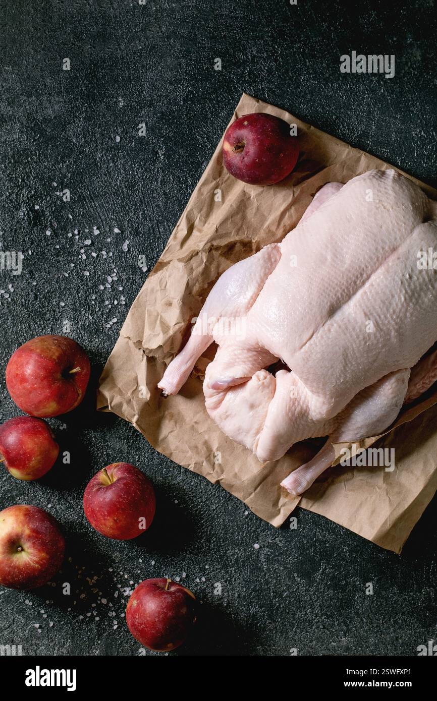 Raw uncooked whole duck on paper over black background Stock Photo - Alamy