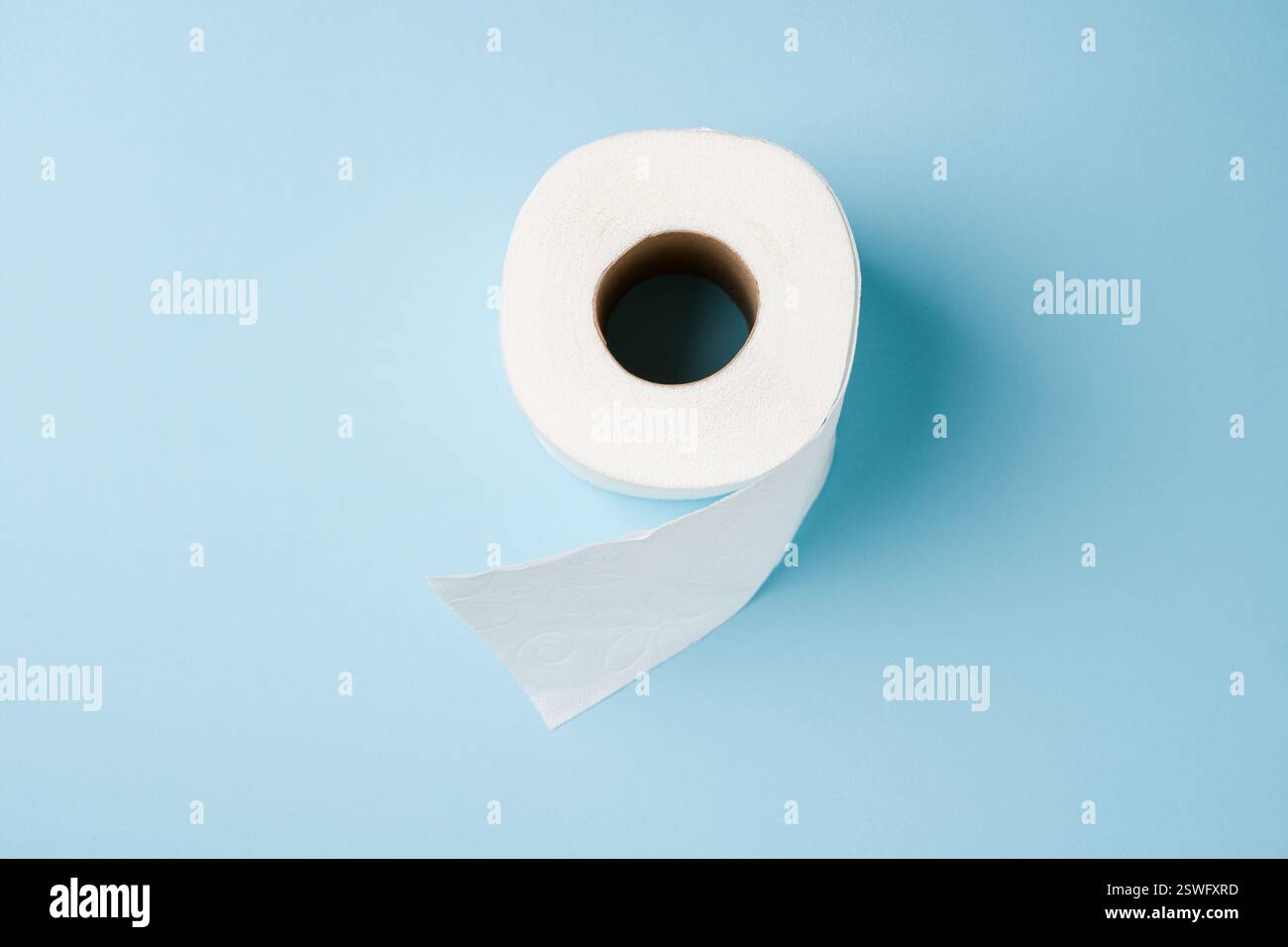 Top view of toilet paper roll on blue background Stock Photo - Alamy