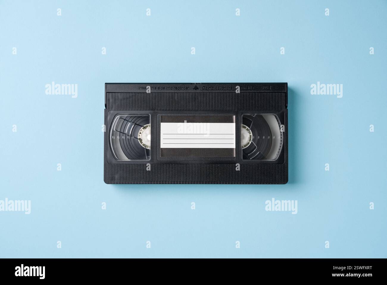 Top view of old VHS video tape on blue background Stock Photo - Alamy