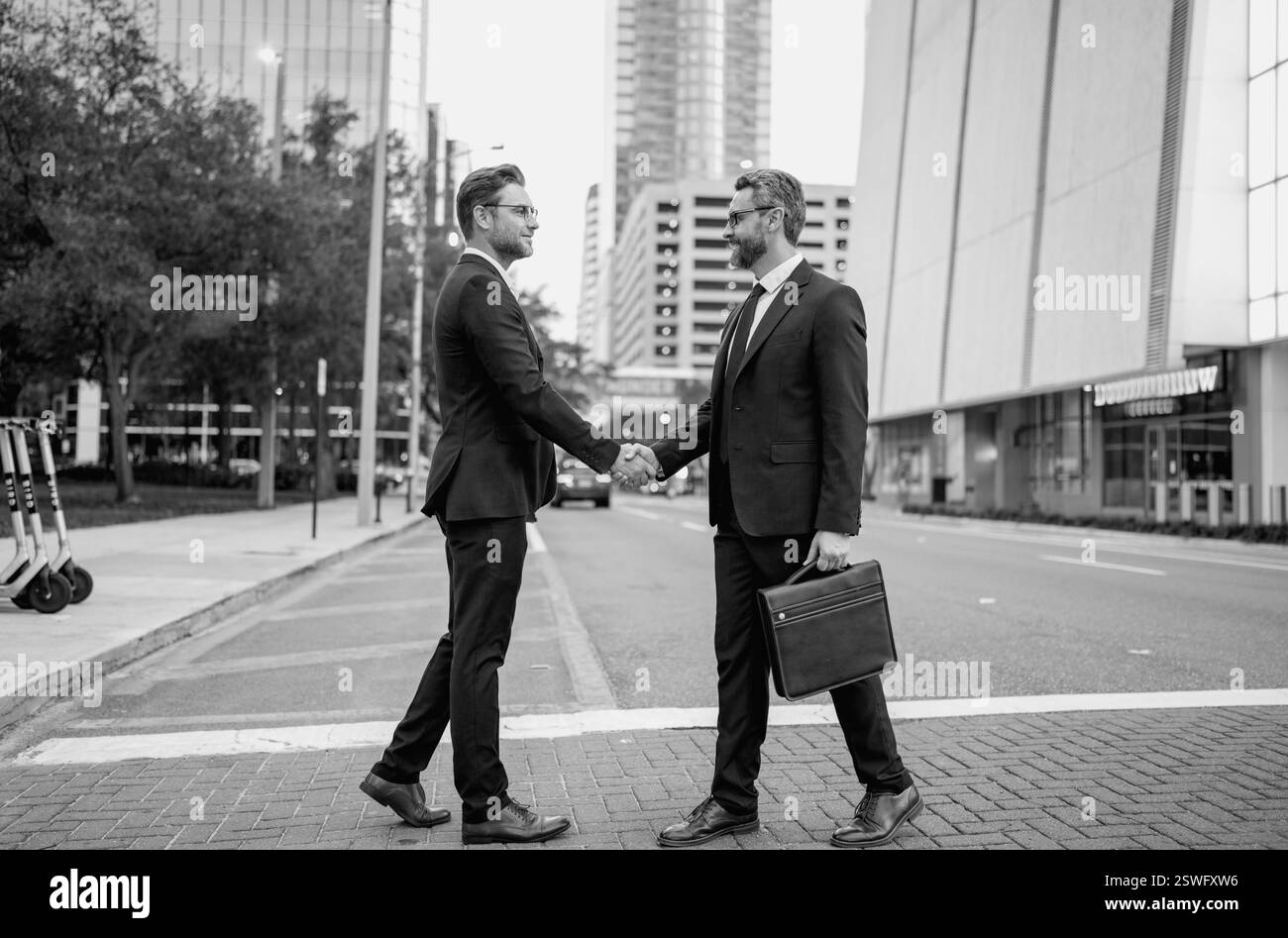 Business man shaking hands. Two businessmen handshake outdoor ...