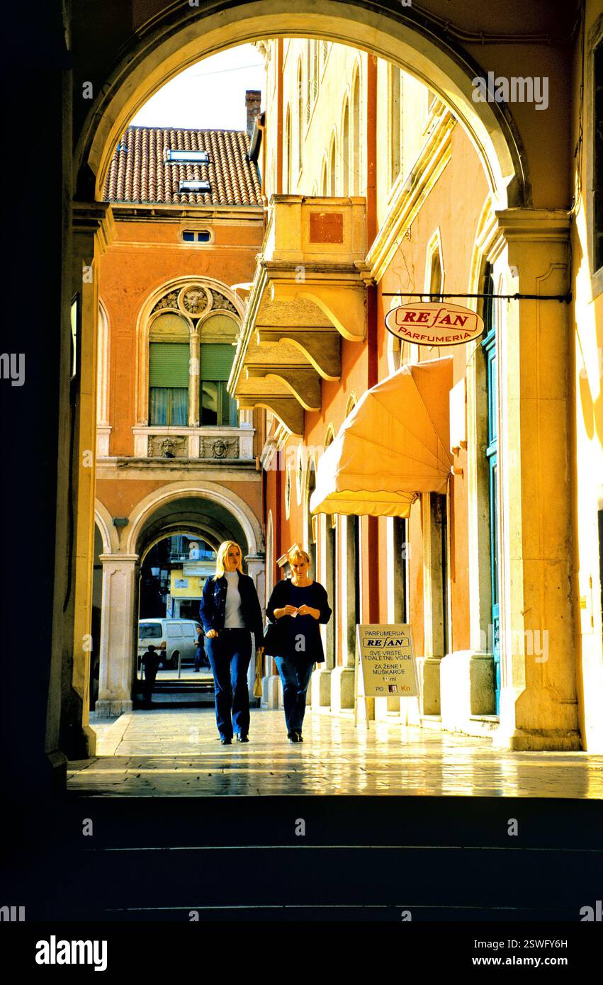 2 woman walking under archway, Split, Croatia, 2002 Stock Photo - Alamy