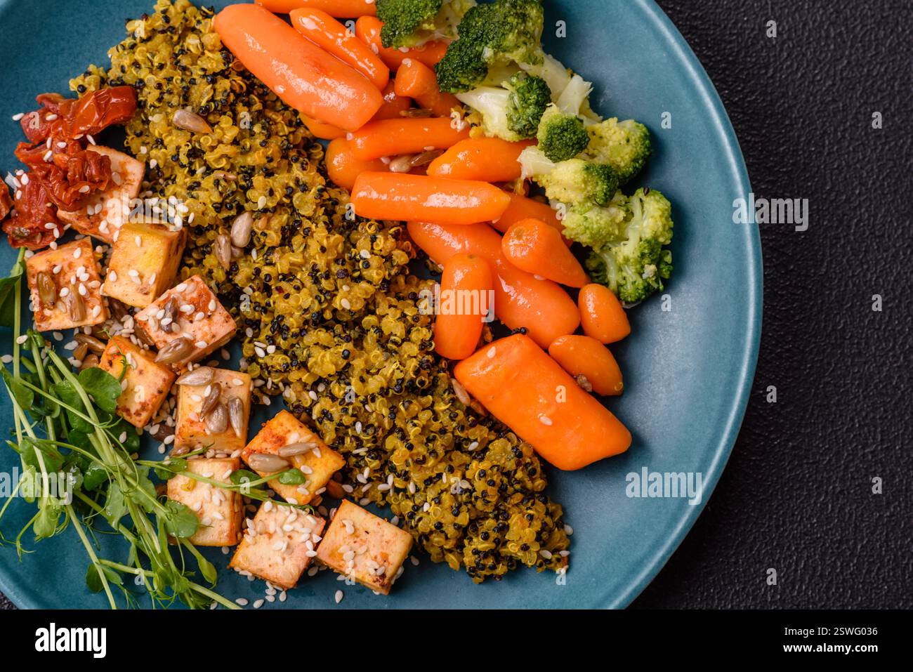 Quinoa bowl with tofu, steamed vegetables, grains, seeds and spices ...
