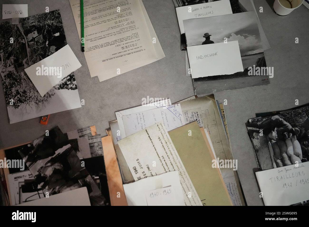 Archival documents on a table as French artist Shuck One prepares a ...