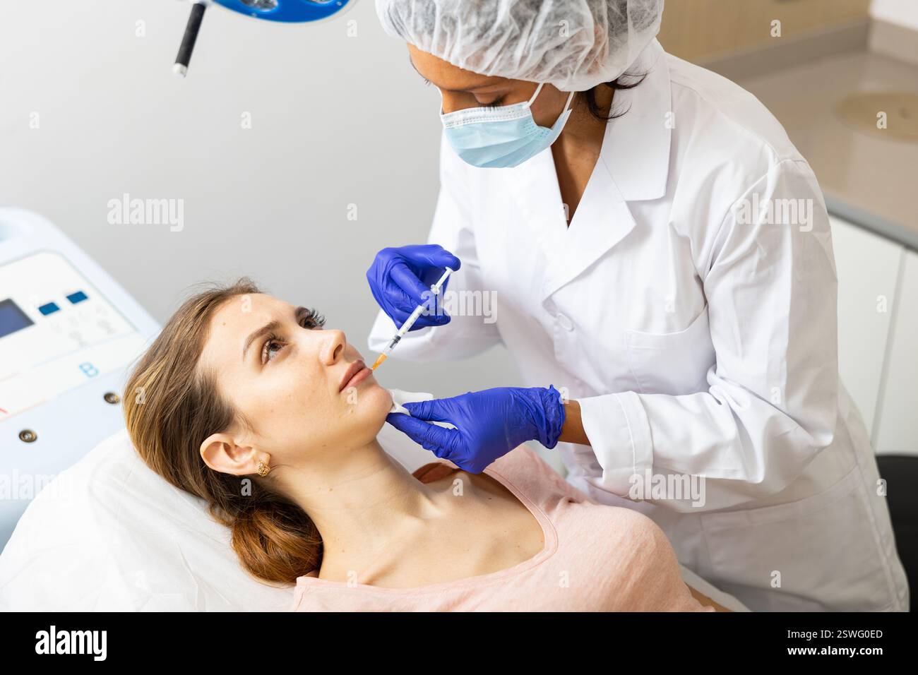 Female patient getting beauty injection for lips Stock Photo - Alamy