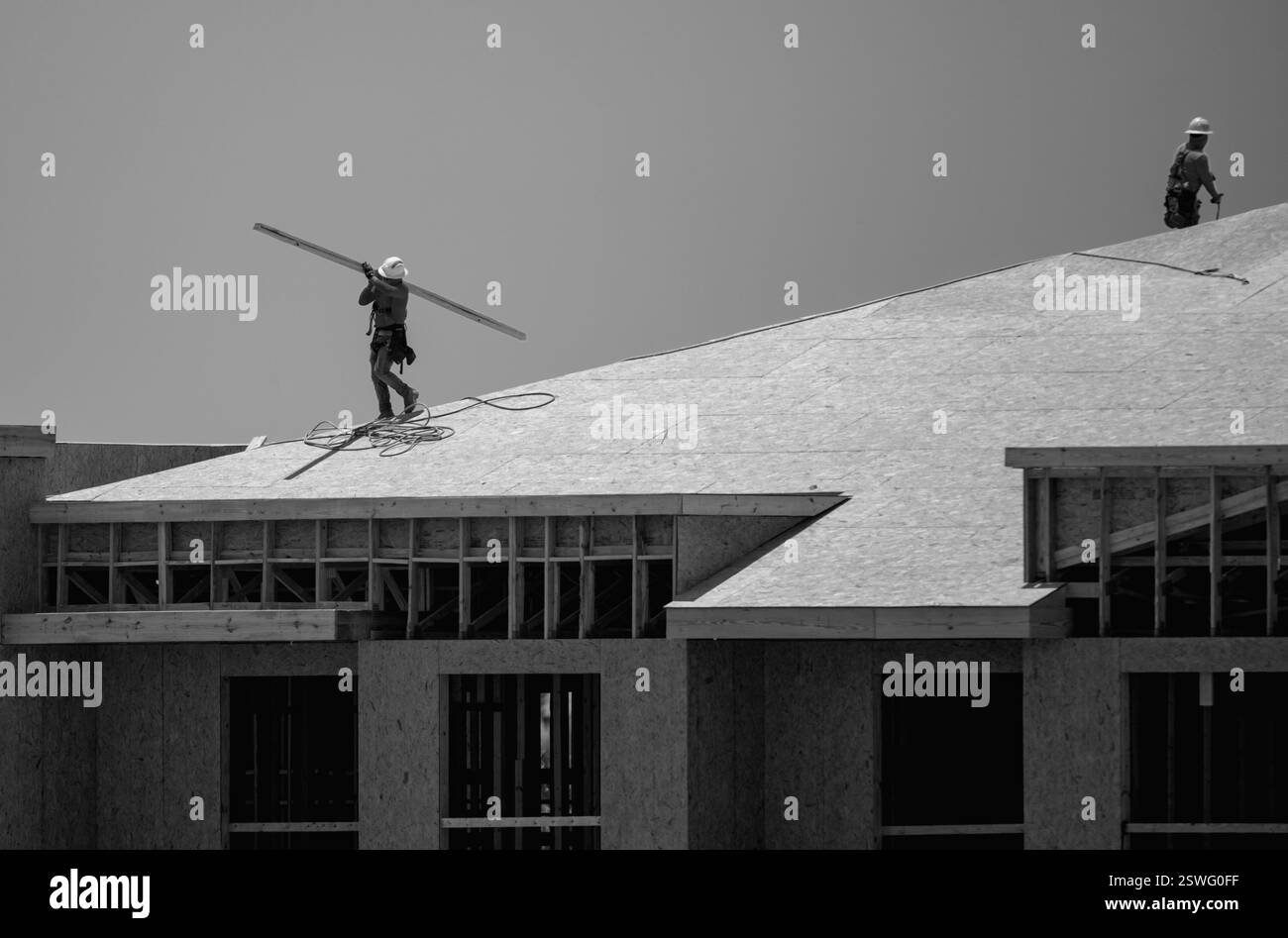 Roofing on rooftop. Builder roofer install new roof. Construction ...