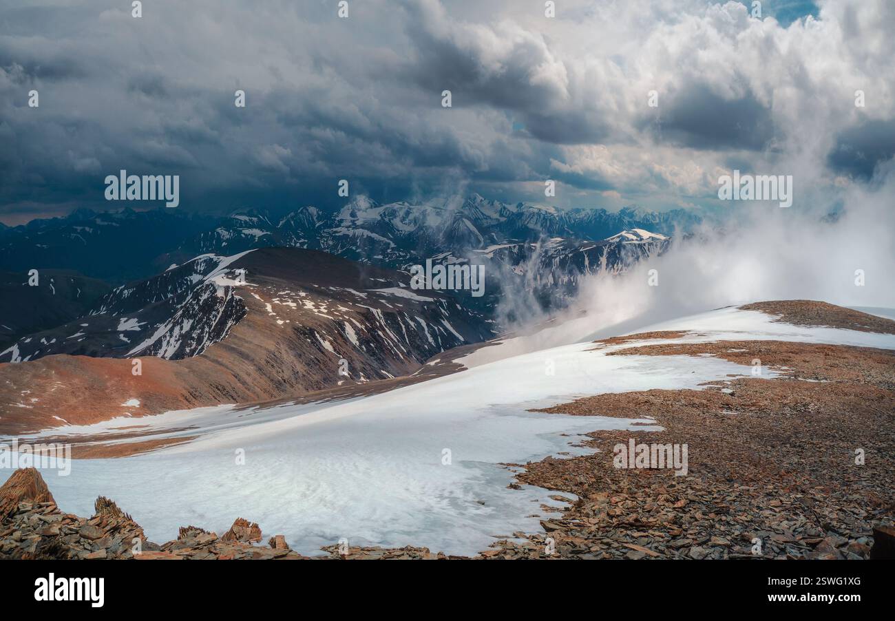 Snow storm on the top of a mountain. Wonderful dramatic landscape with big snowy mountain peaks ...