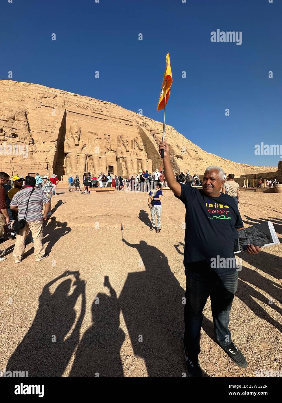 Aswan, Egypt - October 21, 2023: Tour guide with a flag in front of the ...