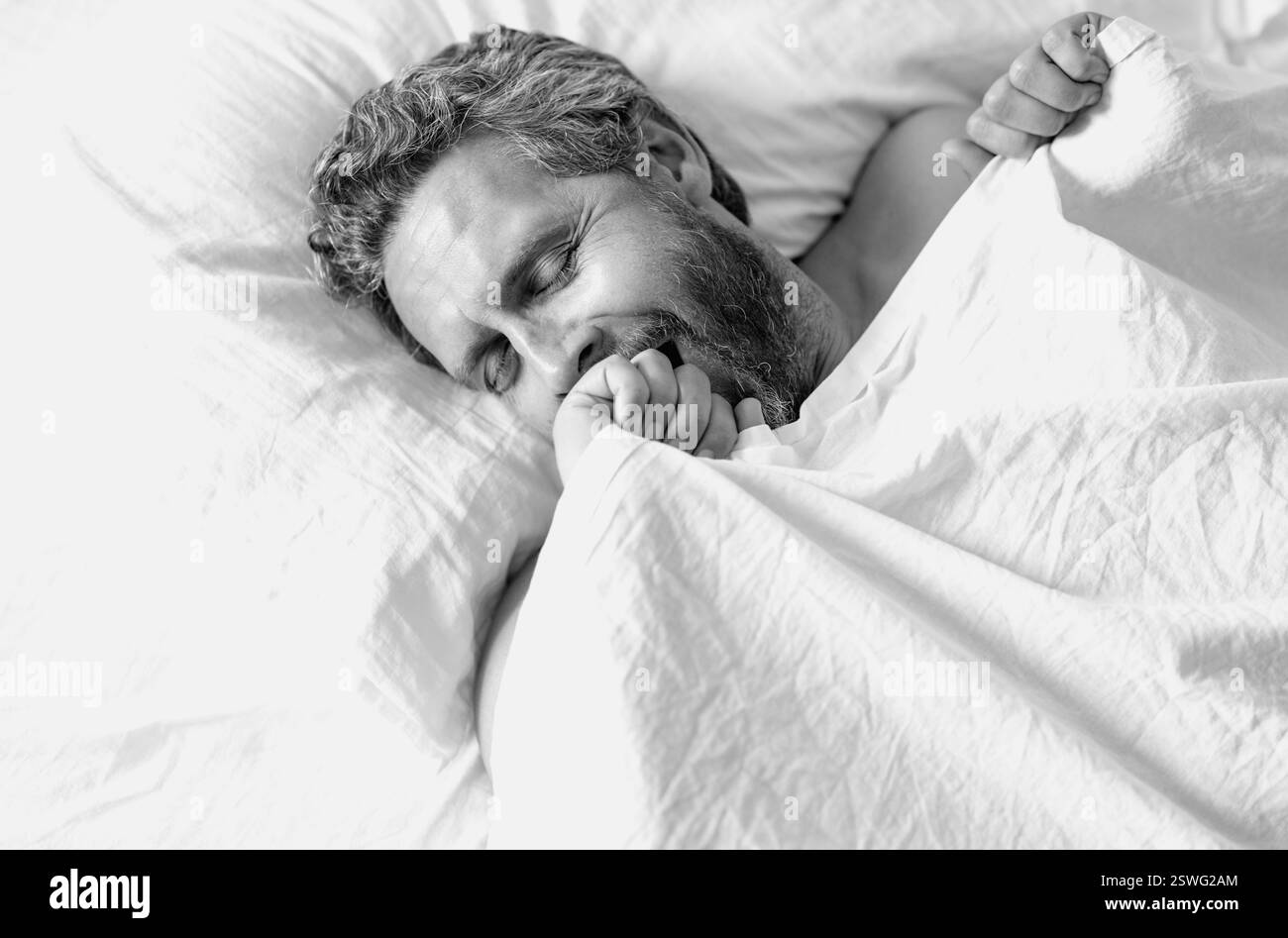 Male head on pillow. Gray hair man yawning in white bed. Senior man ...
