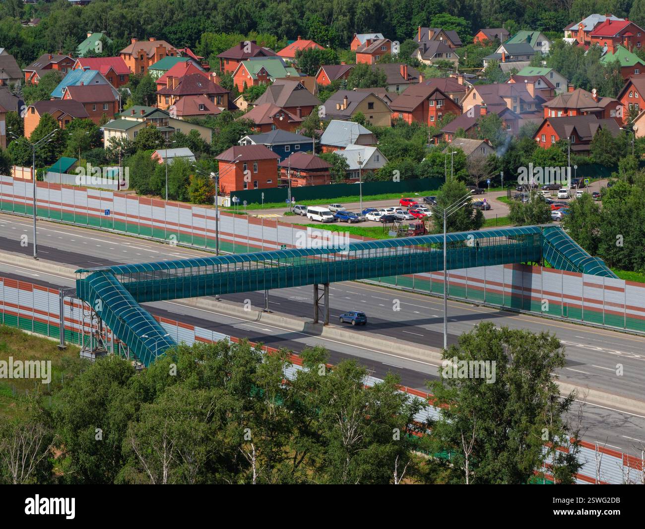 Covered pedestrian bridge over the highway. Pedestrian crosswalk over ...
