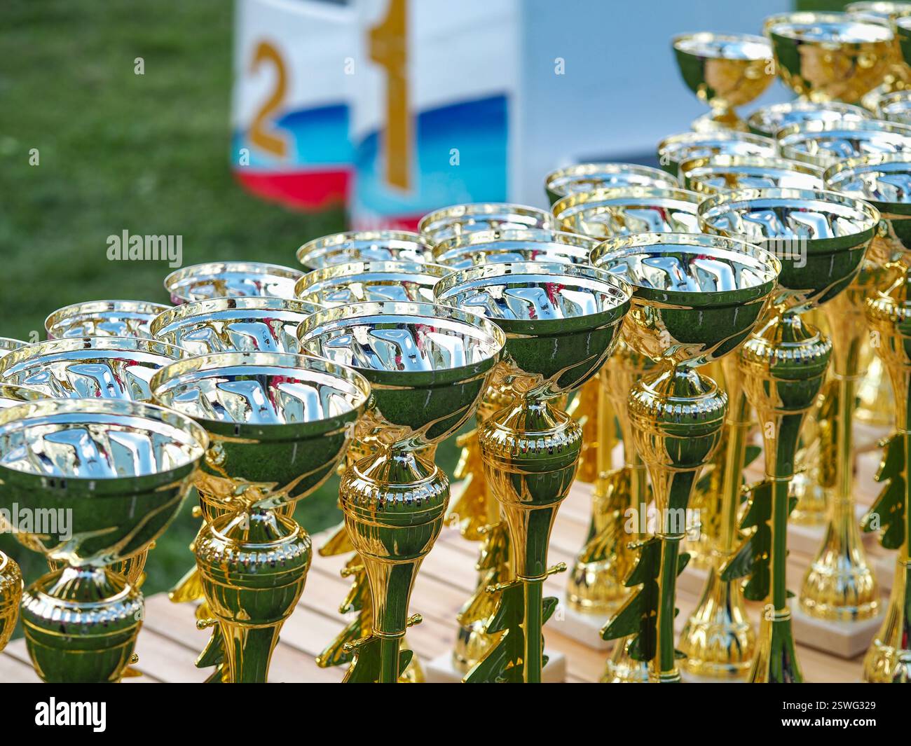 Gold cups are on the table before the presentation Stock Photo - Alamy