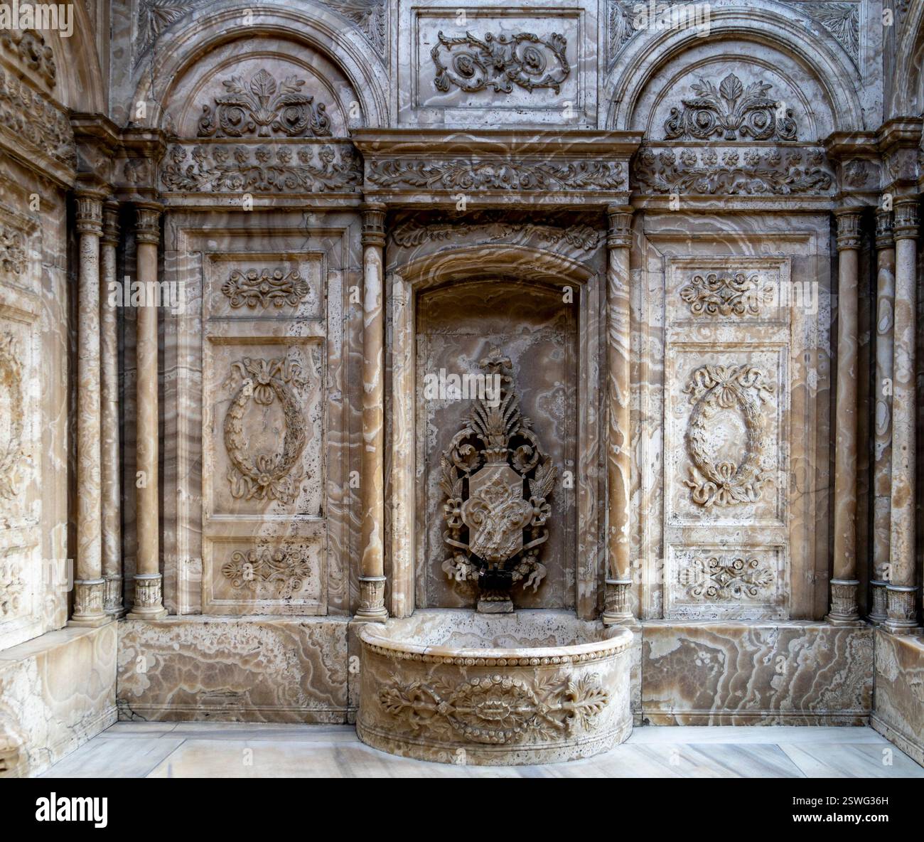 An intricately designed marble wall with ornate carvings and a central ...