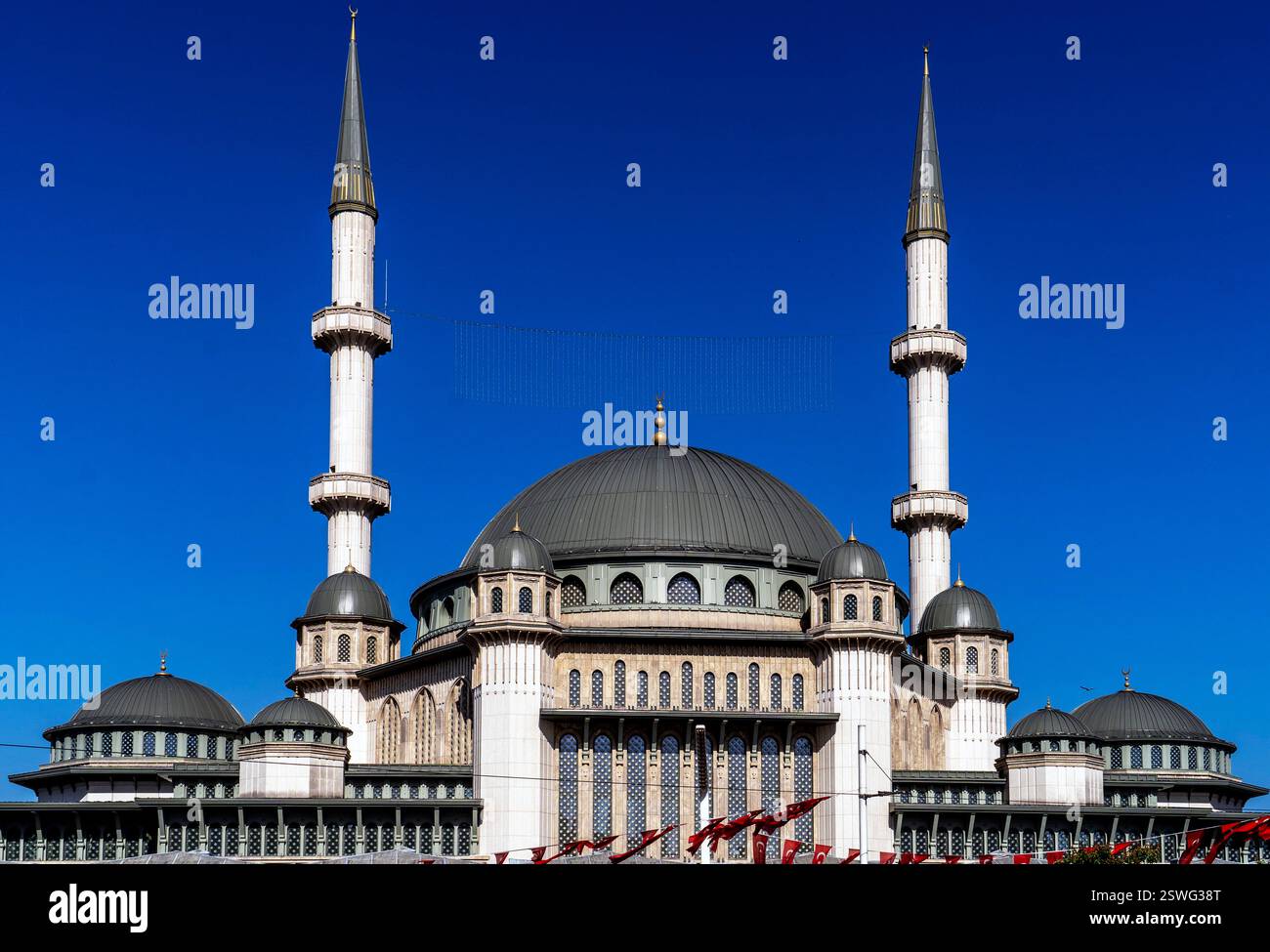 A grand mosque featuring multiple domes and tall minarets against a ...
