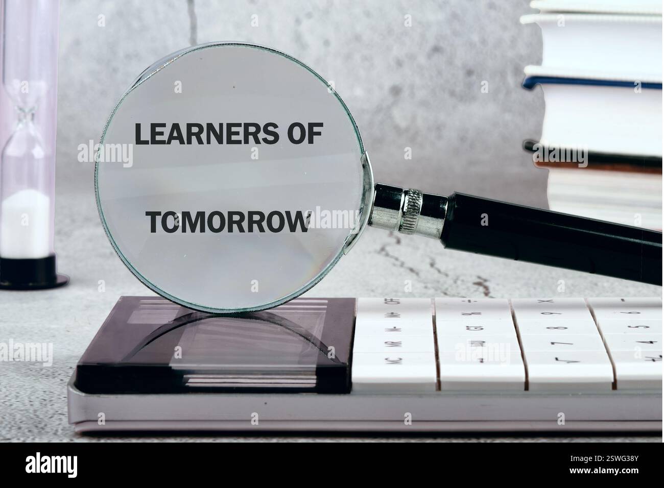 A magnifying glass highlights the phrase learners of tomorrow over a ...