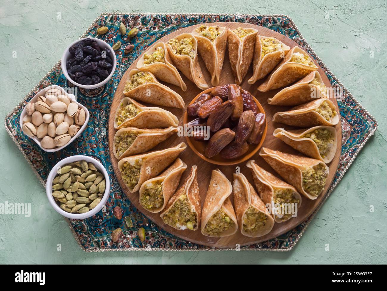 Arab sweets. Arabian pancake stuffed with sweet cheese and pistachios ...