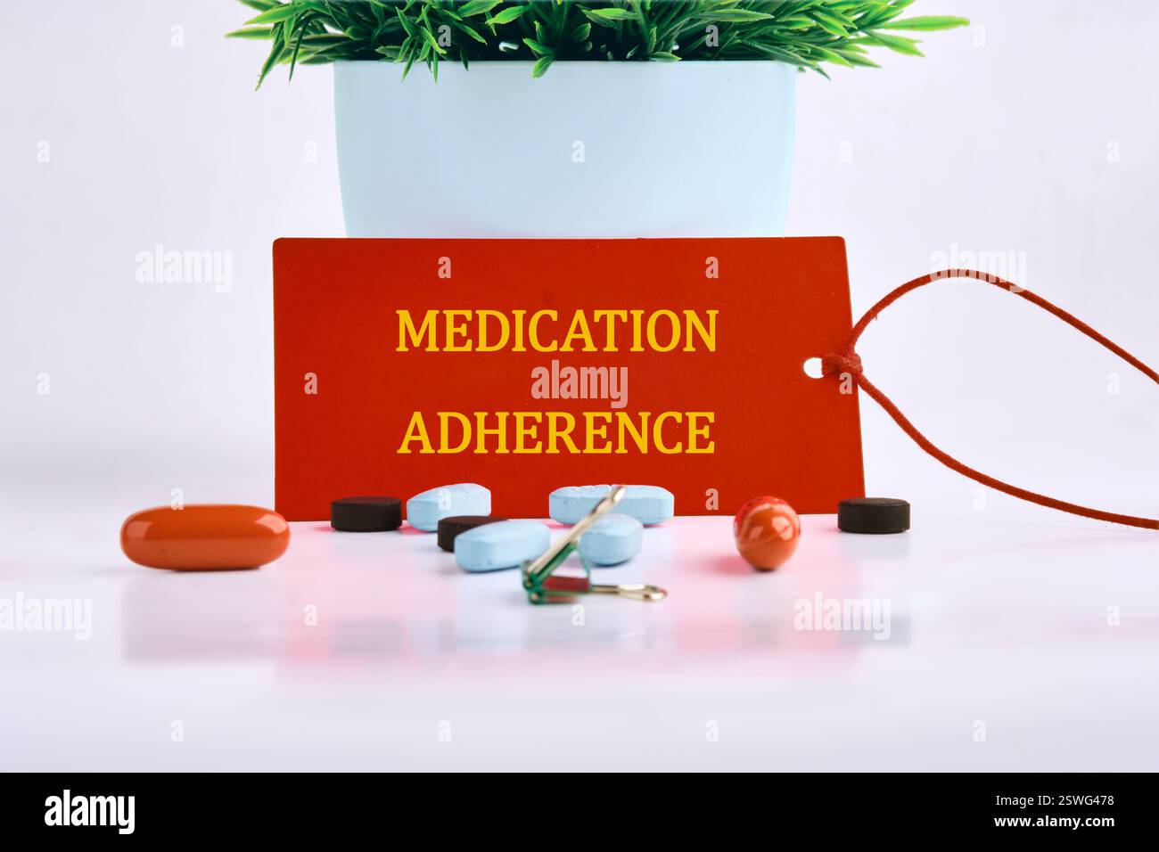 Medication adherence is showcased through pills and a label ...