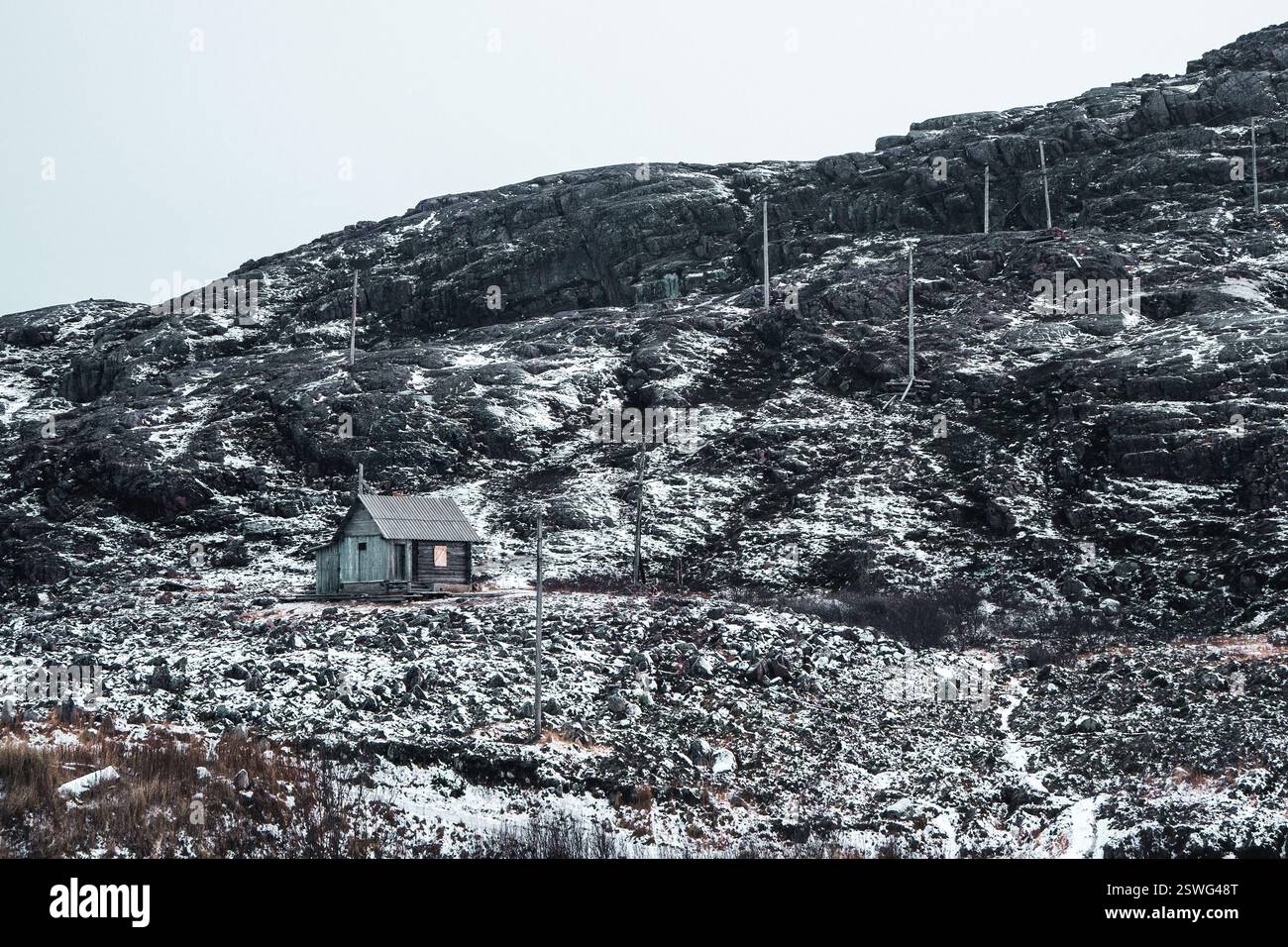Hunting abandoned lodge on an Arctic snow-covered hill. Old authentic ...