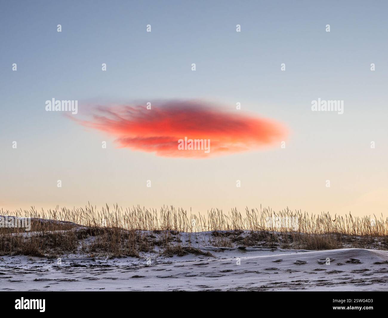 A cloud that looks like a UFO. Lenticular cloud above the ground Stock ...