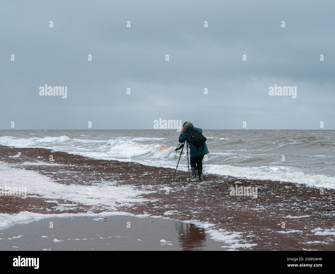The photographer takes a picture of a landscape on the shore of a ...