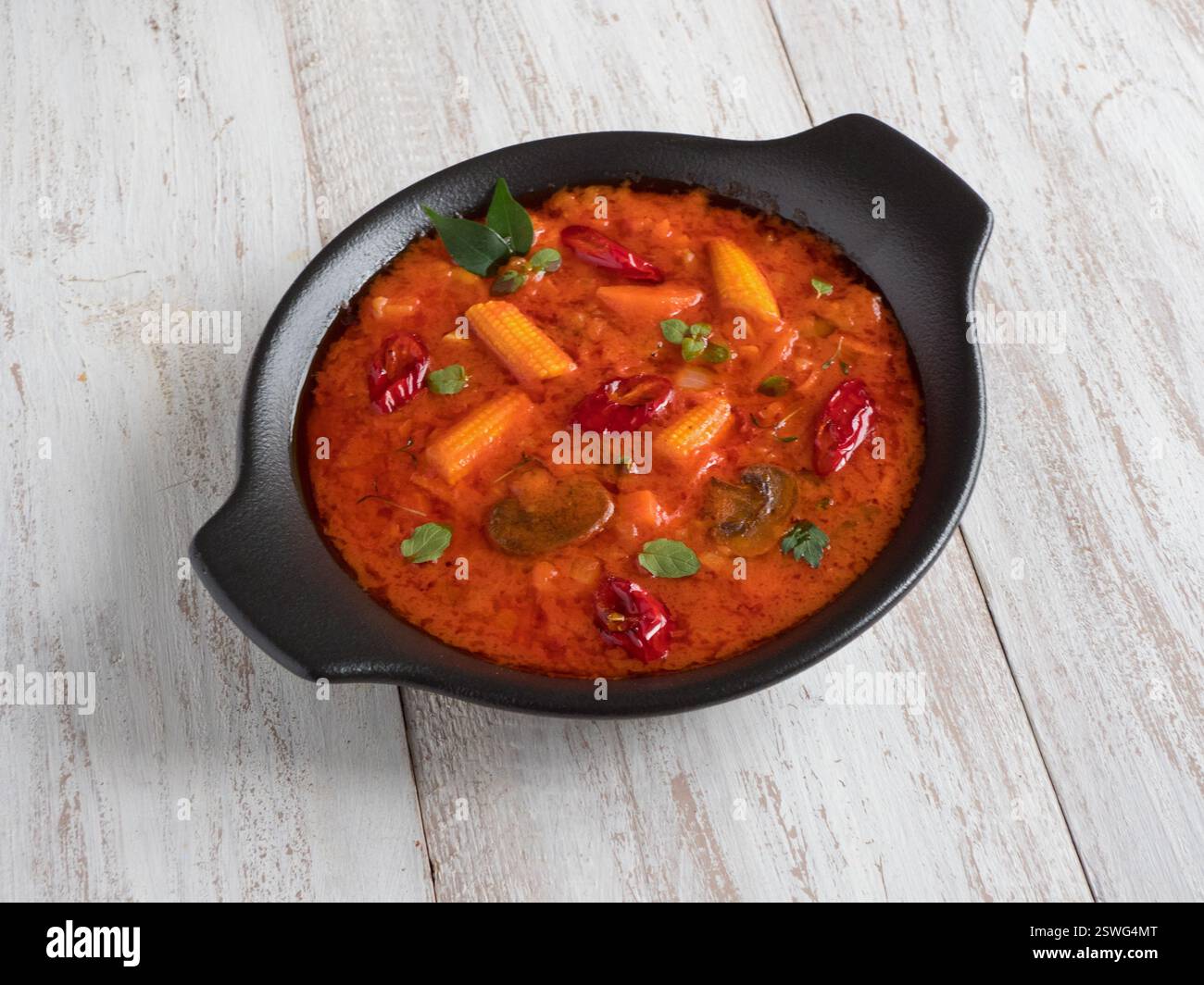 Mixed vegetable Goan curry on a wooden table, Indian food Stock Photo ...