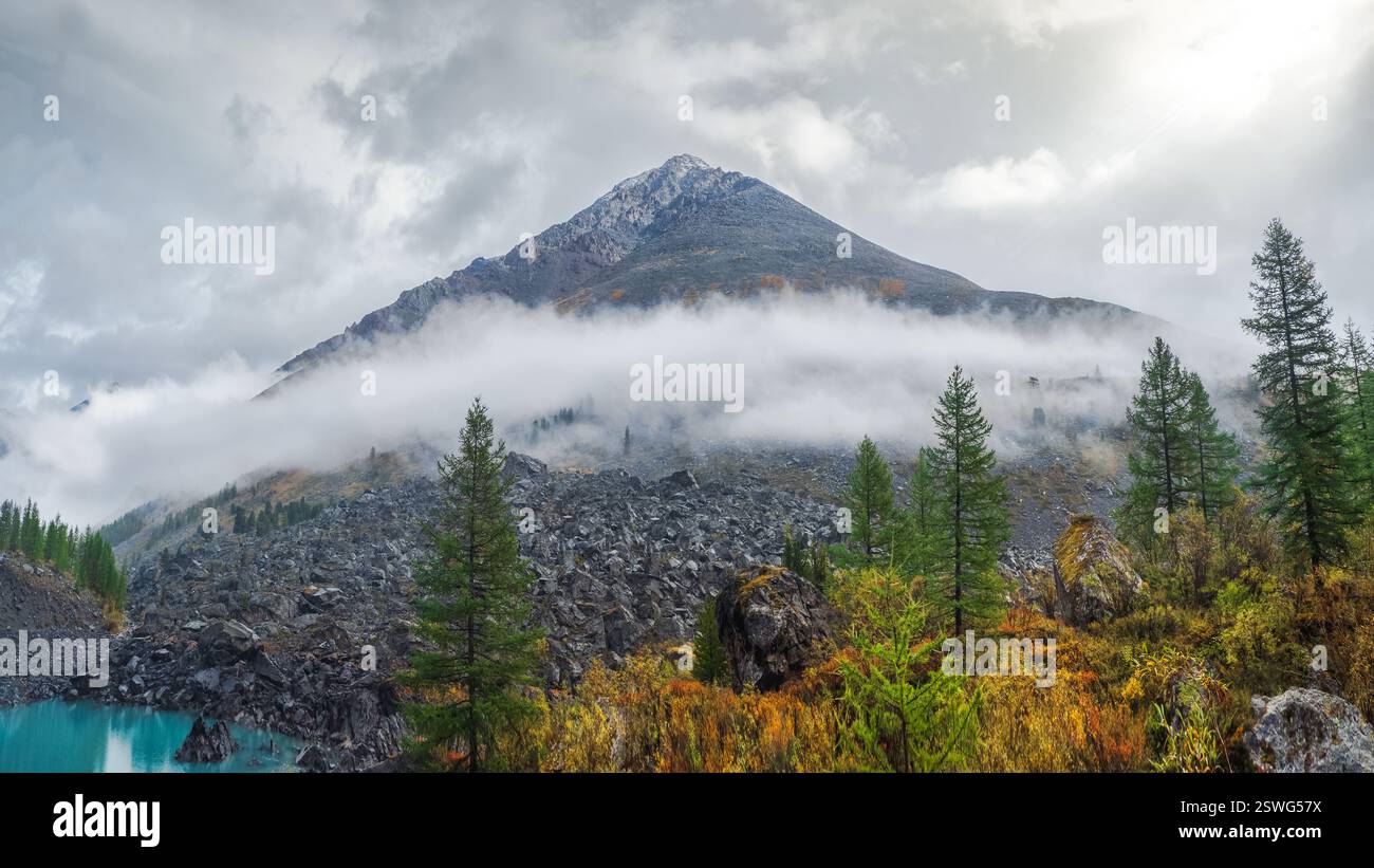 Panoramic view of the autumn mountain, a narrow strip of fog over the ...