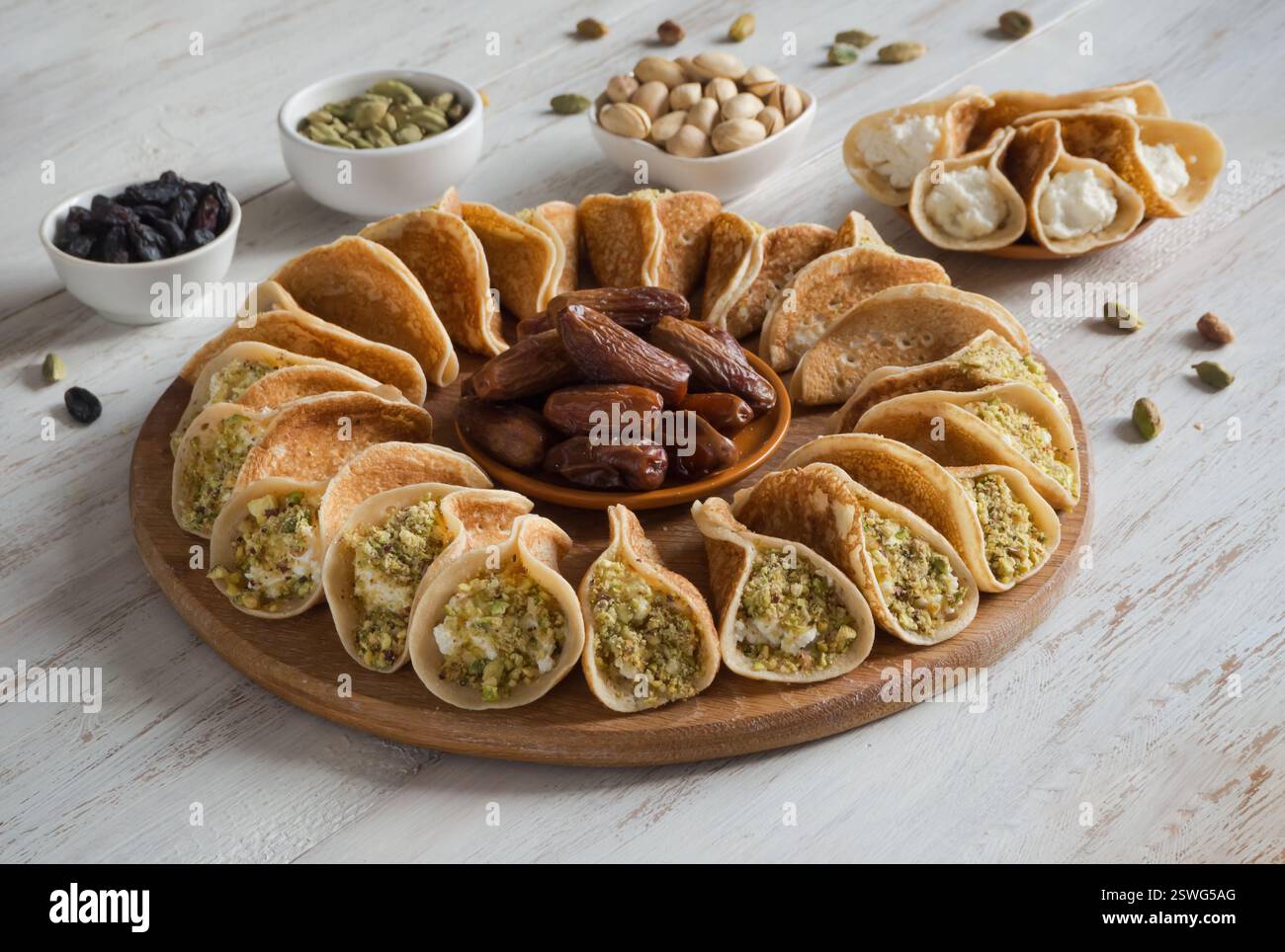 Arab sweets. Arabian pancake stuffed with sweet cheese and pistachios ...