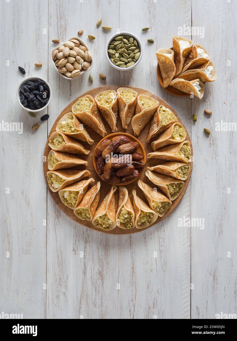 Arab sweets. Arabian pancake stuffed with sweet cheese and pistachios ...