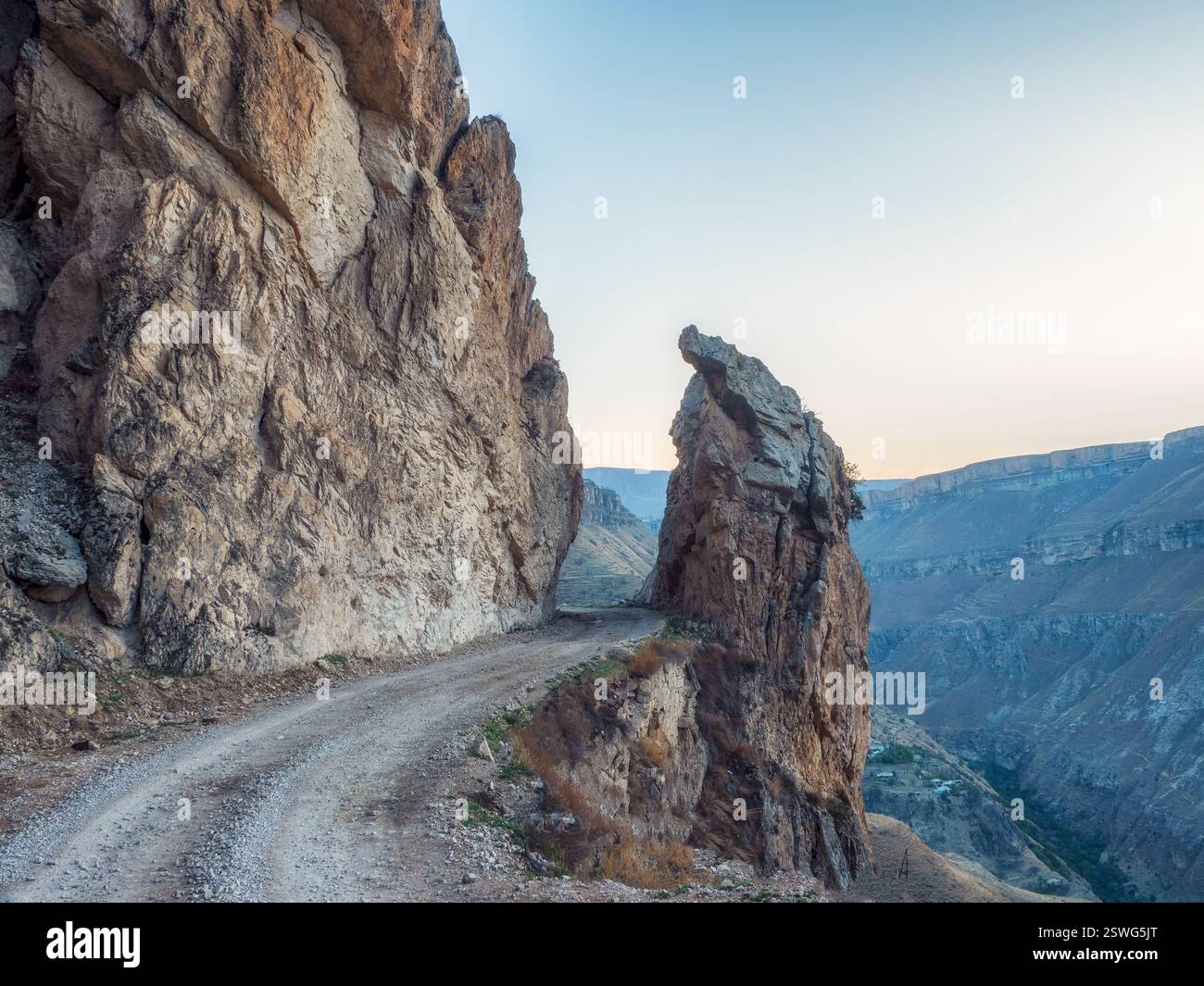 Dangerous narrow cliffside mountain road through sharp rocks ...