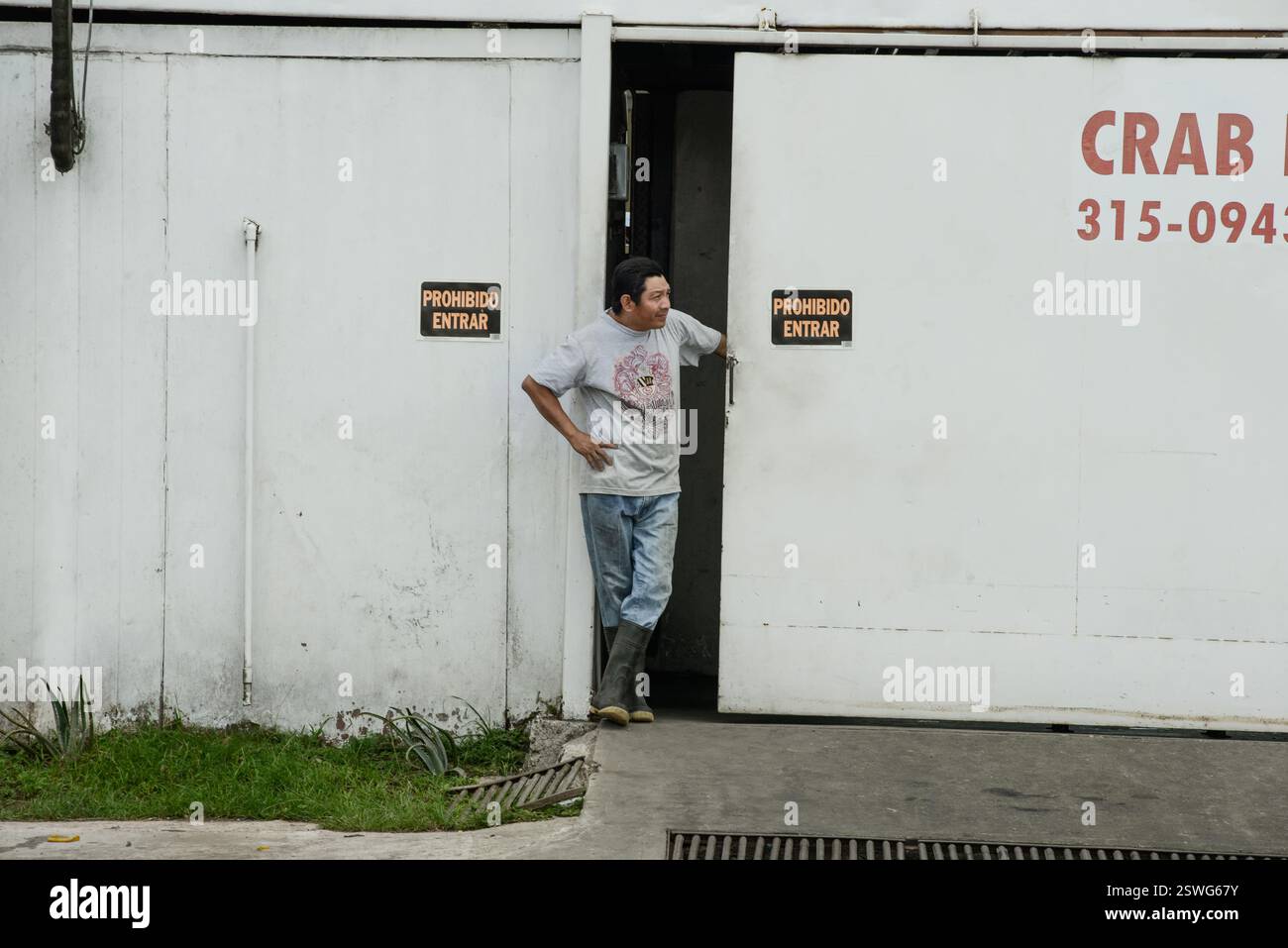 09/06/2020 - Panama: A man stands in the doorway of a white building in ...