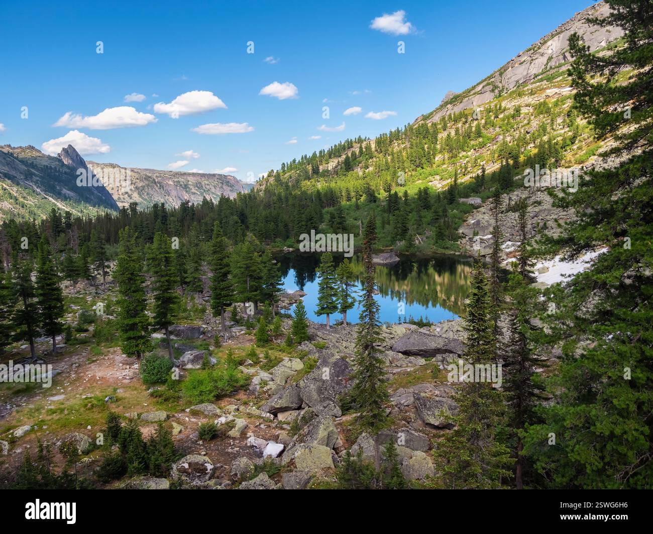 Alpine lake among stone meadows in high mountains Stock Photo - Alamy