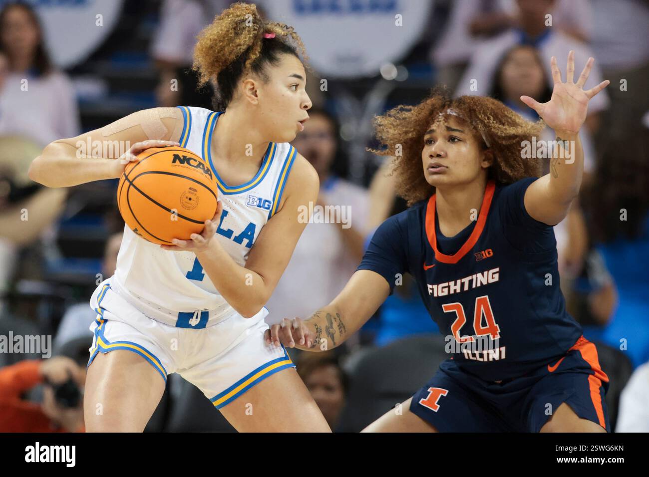 UCLA guard Kiki Rice (1) shields the ball from Illinois guard Adalia ...