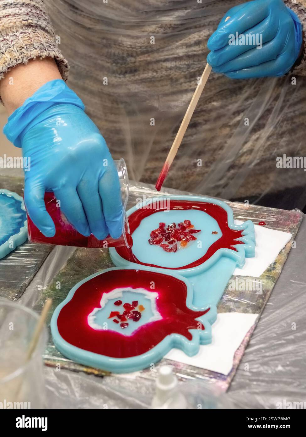 The art process of pouring epoxy resin into a wooden toy. Technology ...