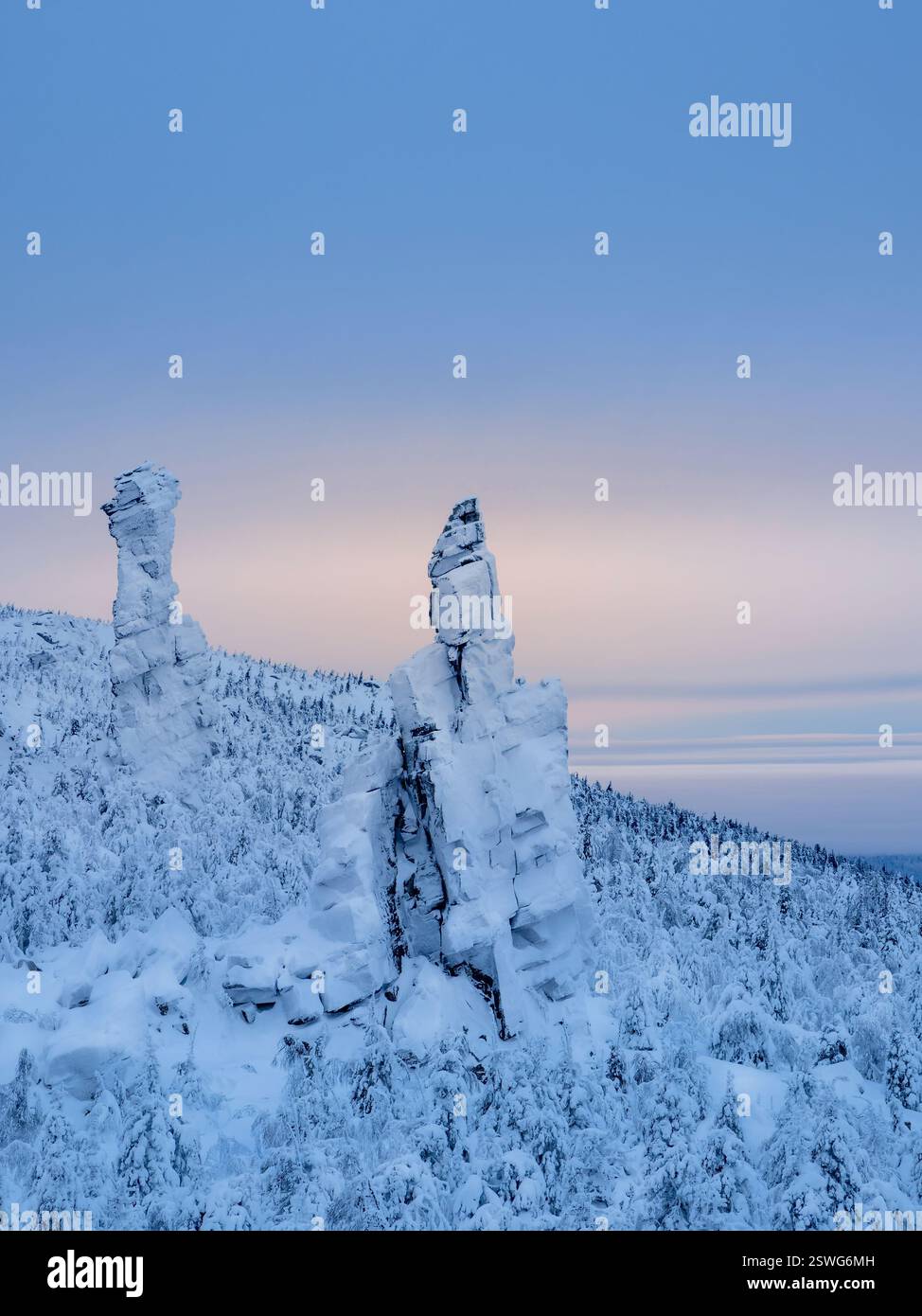Weathering posts high stone cliff covered with snow rise above hi-res ...
