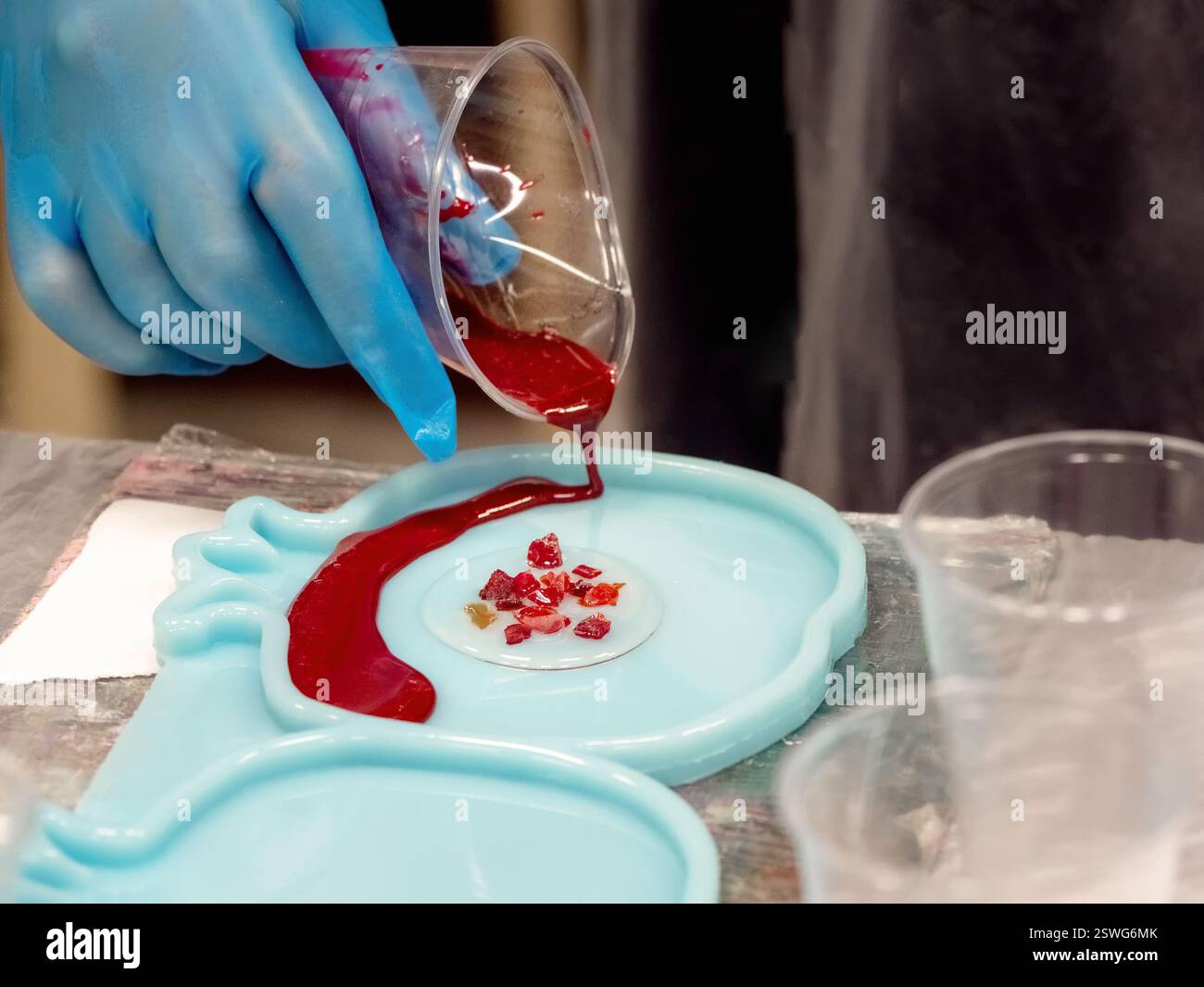 The art process of pouring epoxy resin into a wooden toy. Technology ...