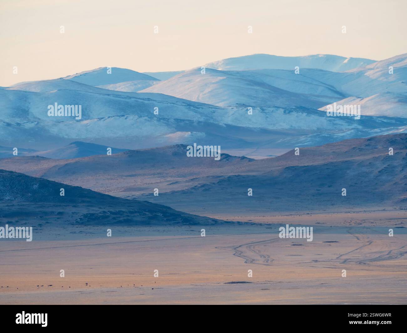 Layers of mountains on distance, soft pink sunset in mountain landscape ...