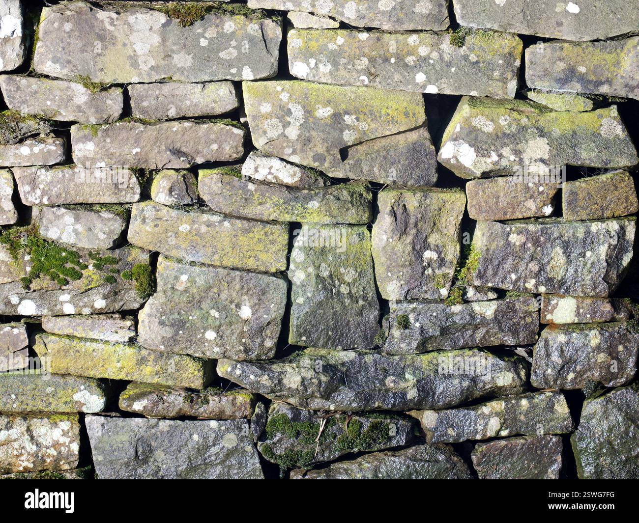 Layered natural stone masonry as a retaining wall for a weir. Perfect ...