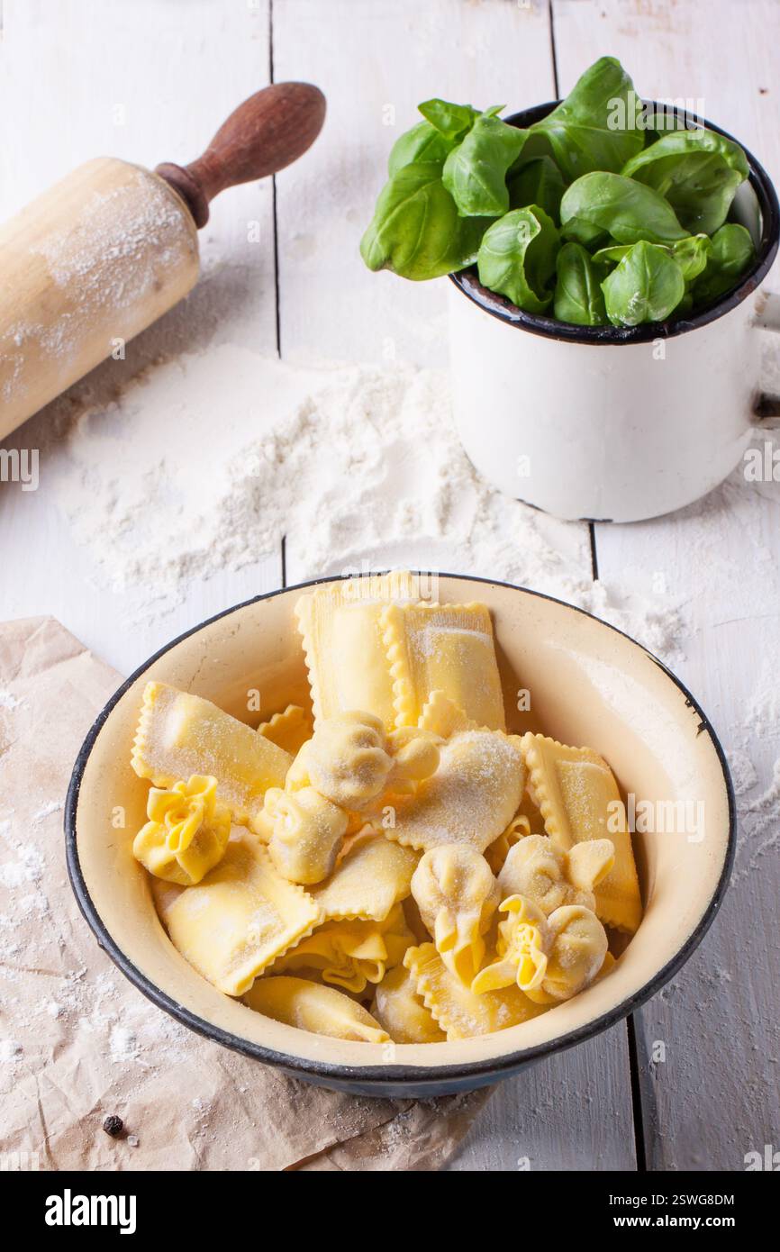 Pasta ravioli with flour and basil Stock Photo - Alamy