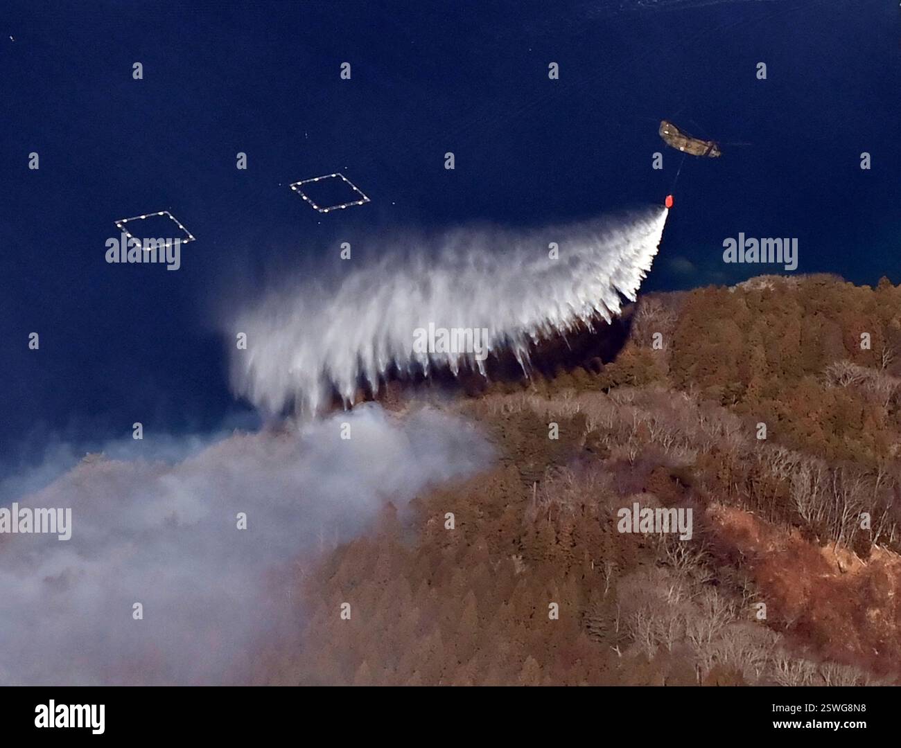 An aerial photo shows a forest fire, continues to spread in Ofunato ...