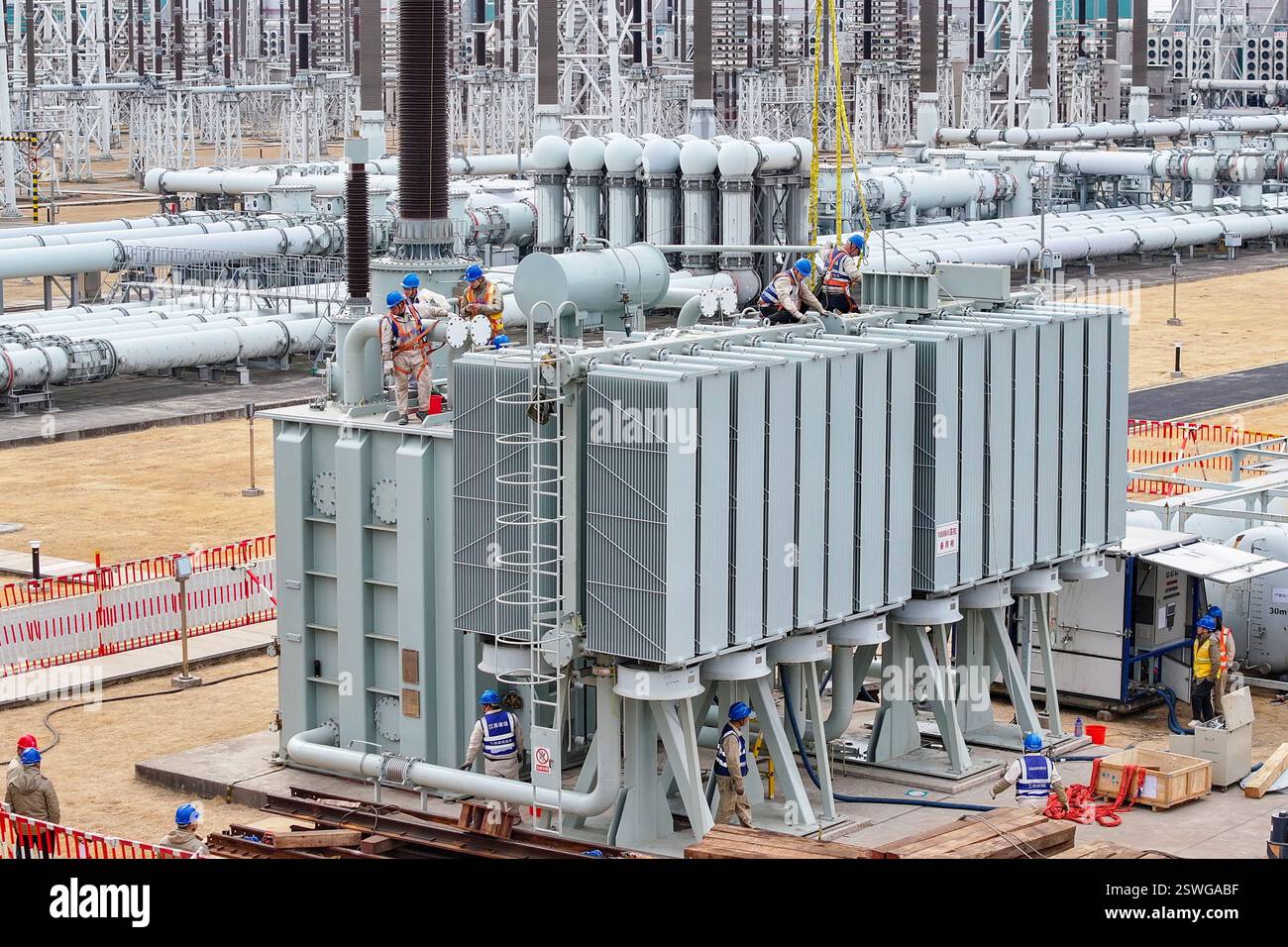 TAIZHOU, CHINA - FEBRUARY 21, 2025 - Construction workers replaced a ...