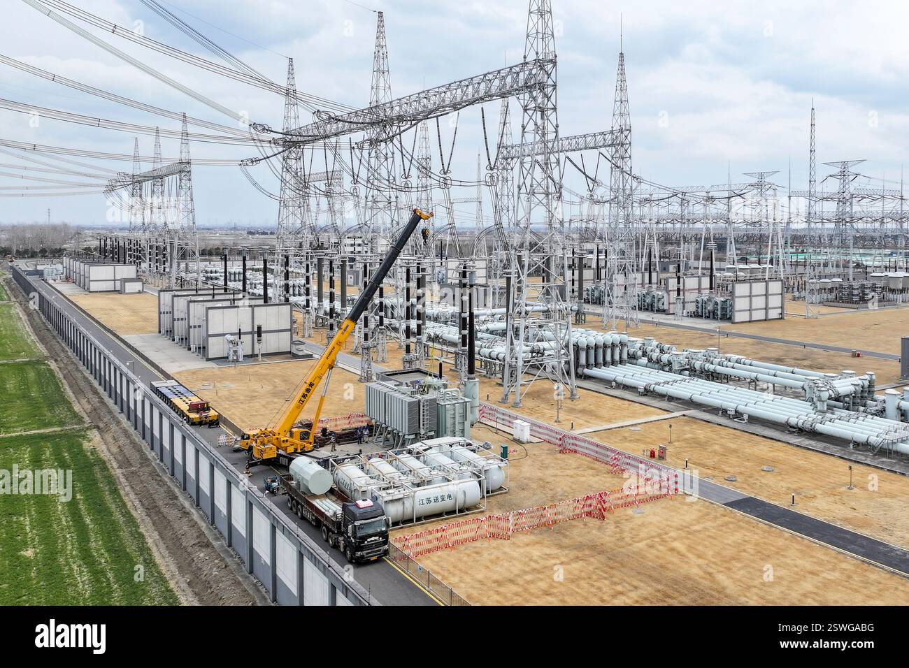 TAIZHOU, CHINA - FEBRUARY 21, 2025 - Construction workers replaced a ...
