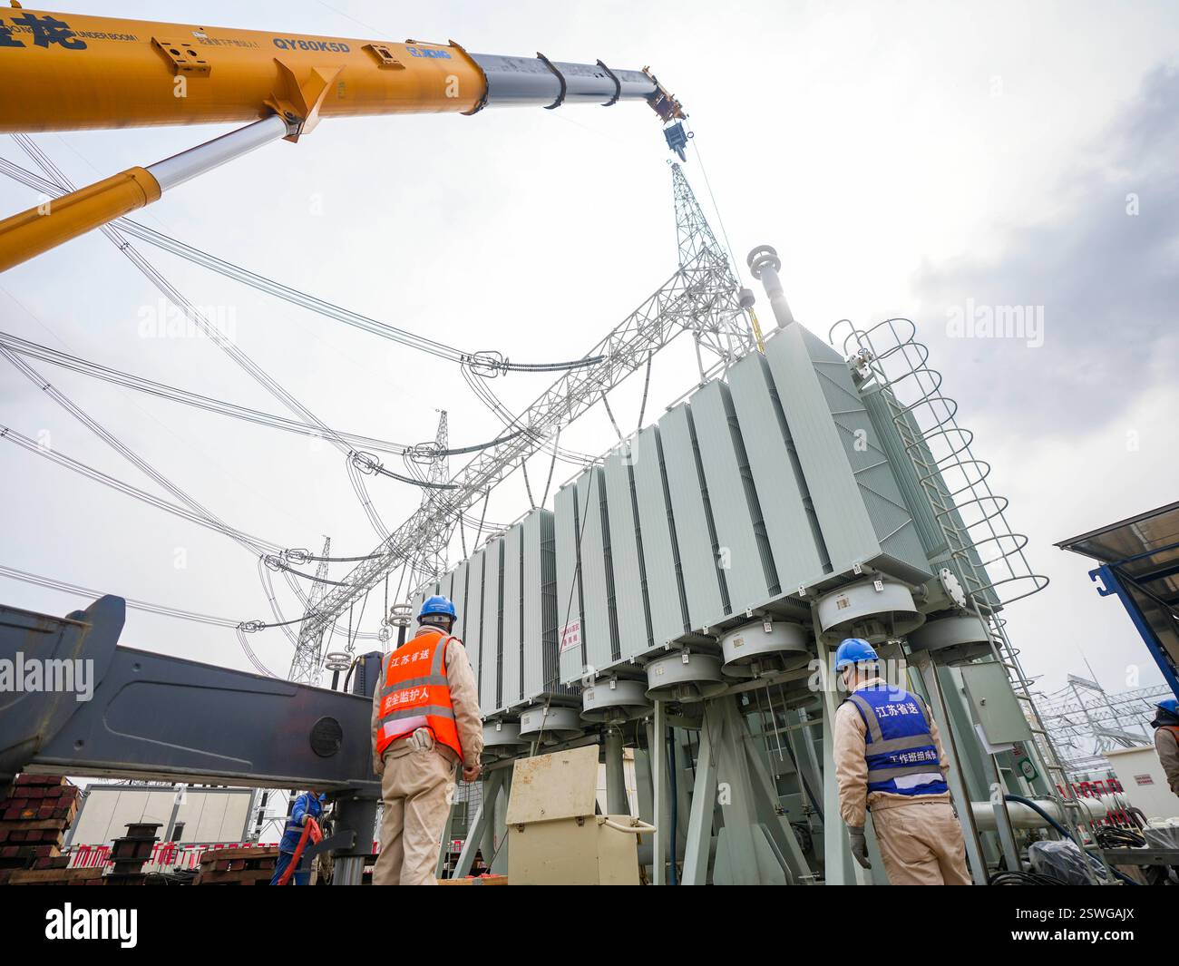 TAIZHOU, CHINA - FEBRUARY 21, 2025 - Construction workers replaced a ...