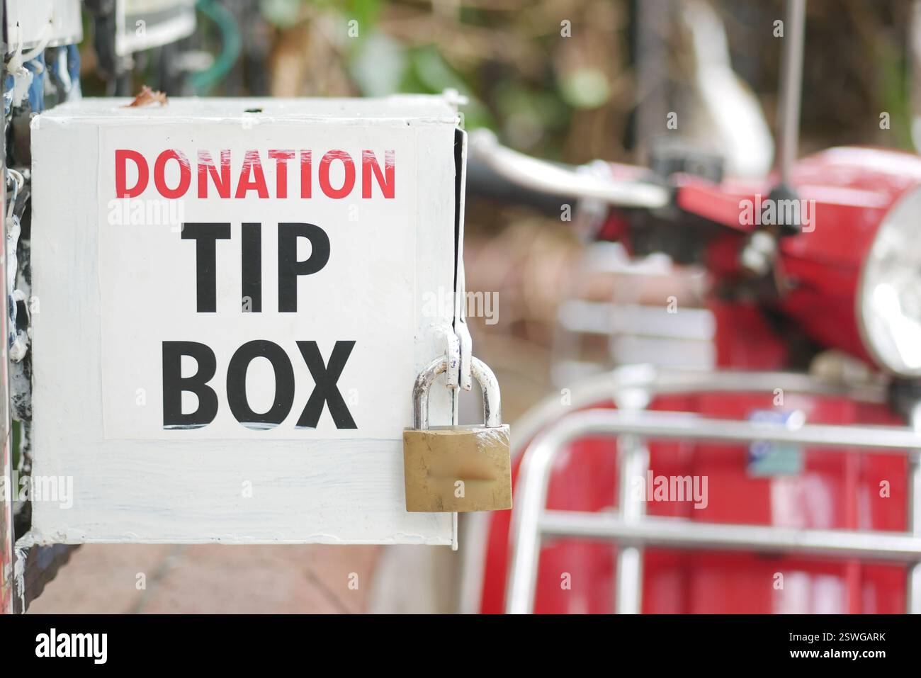 Donation tip box outside with a padlock in a public area Stock Photo ...