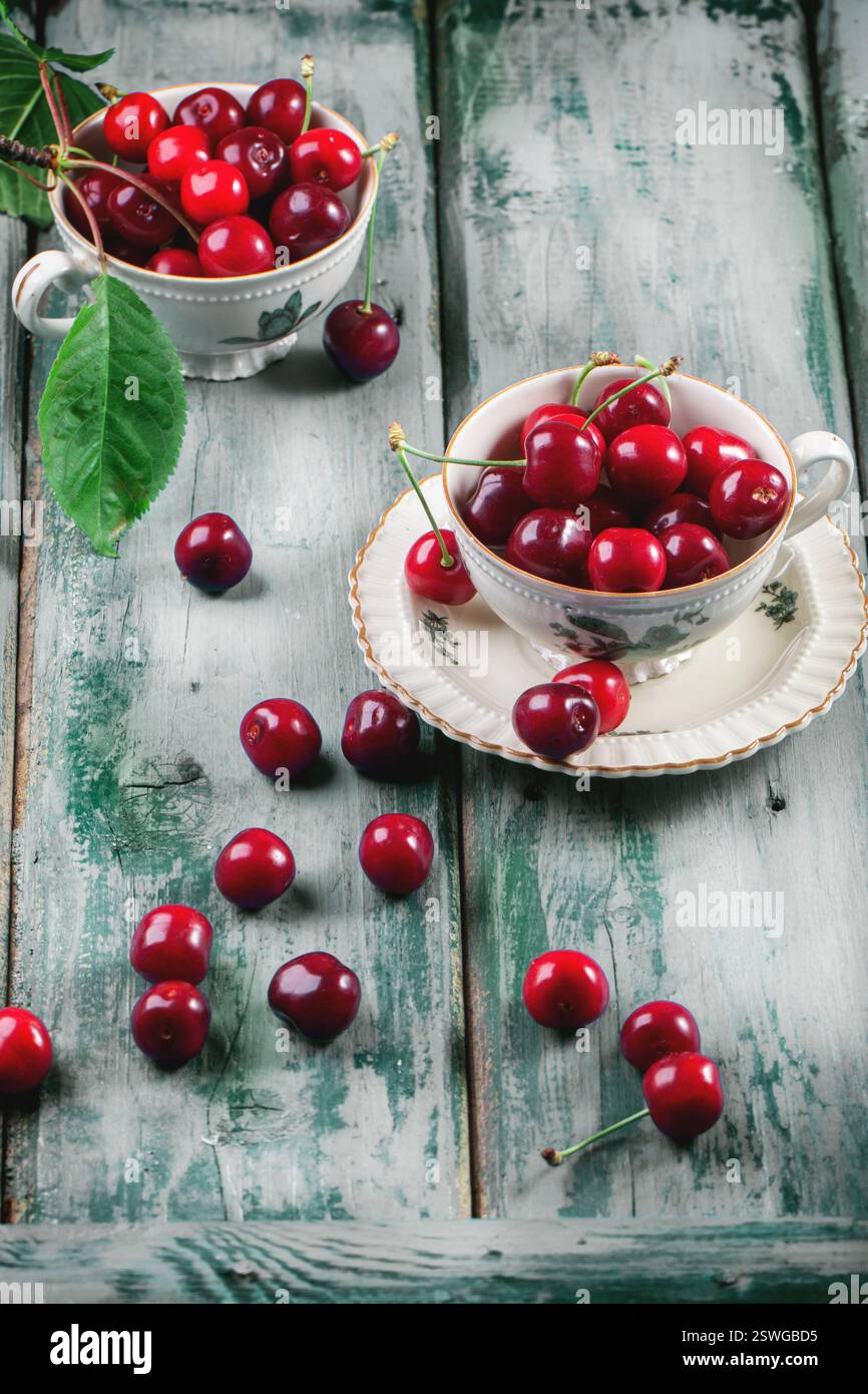 Fresh cherries in vintage tea cup Stock Photo - Alamy