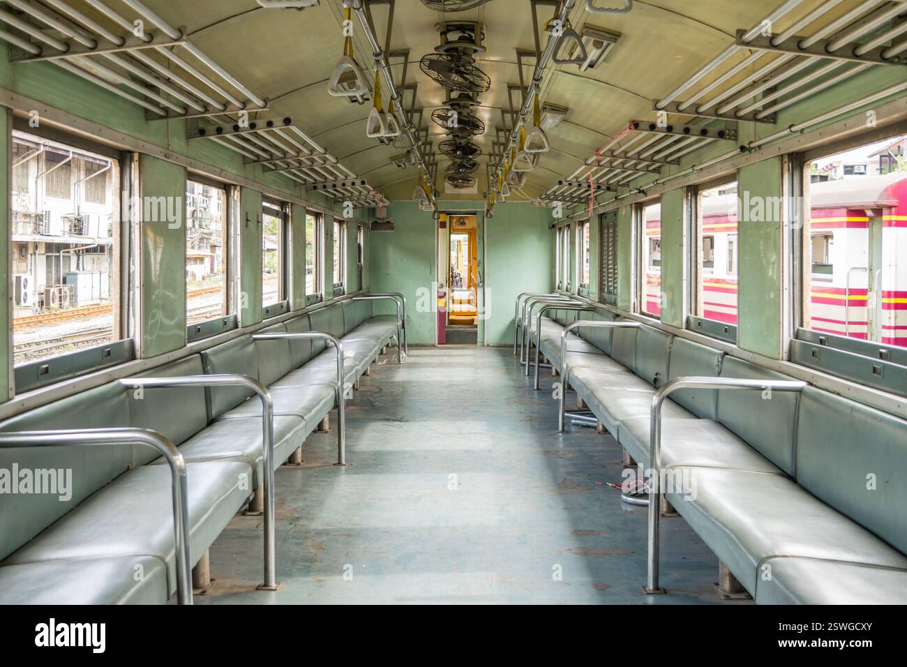 Inside of old public Thai railway train cabin with seats, handrails ...