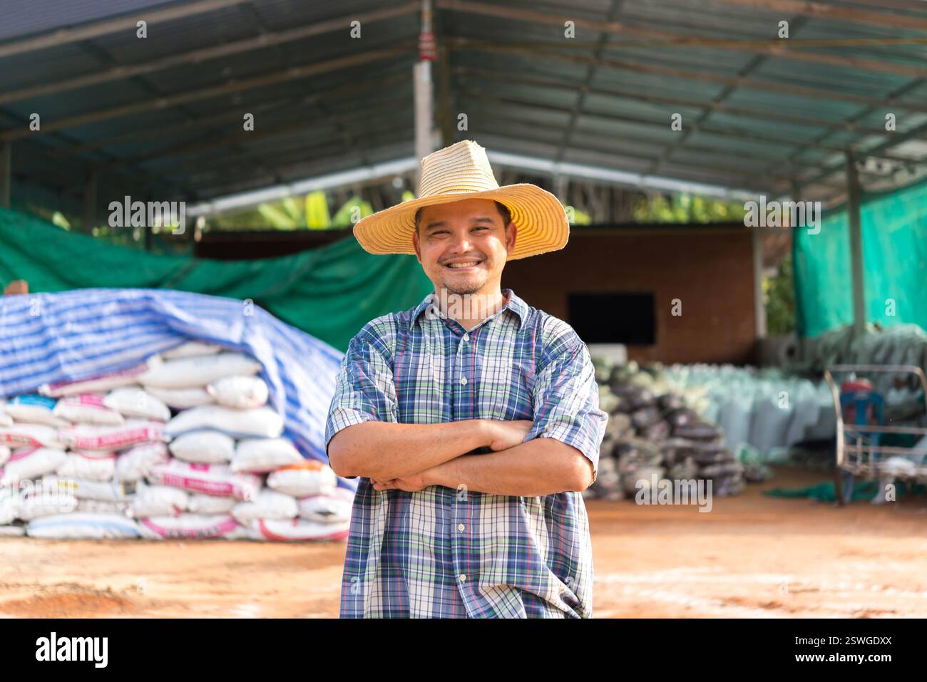 Asian man farmer agriculturist happy at a Fertilizer composting plant ...