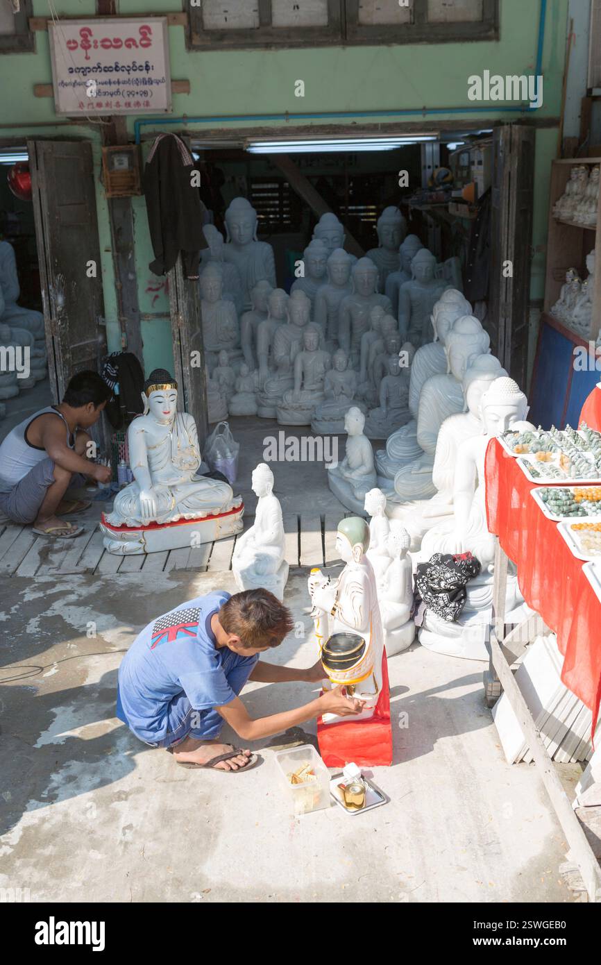 Myanmar, Mandalay, stone masons carving various images of the Buddha ...